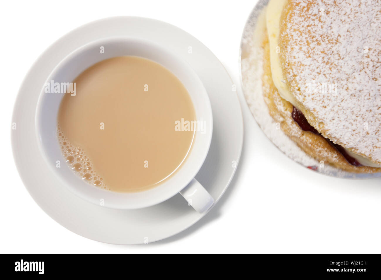 High angle view of tea cup and powdered sugar cake slice Stock Photo ...