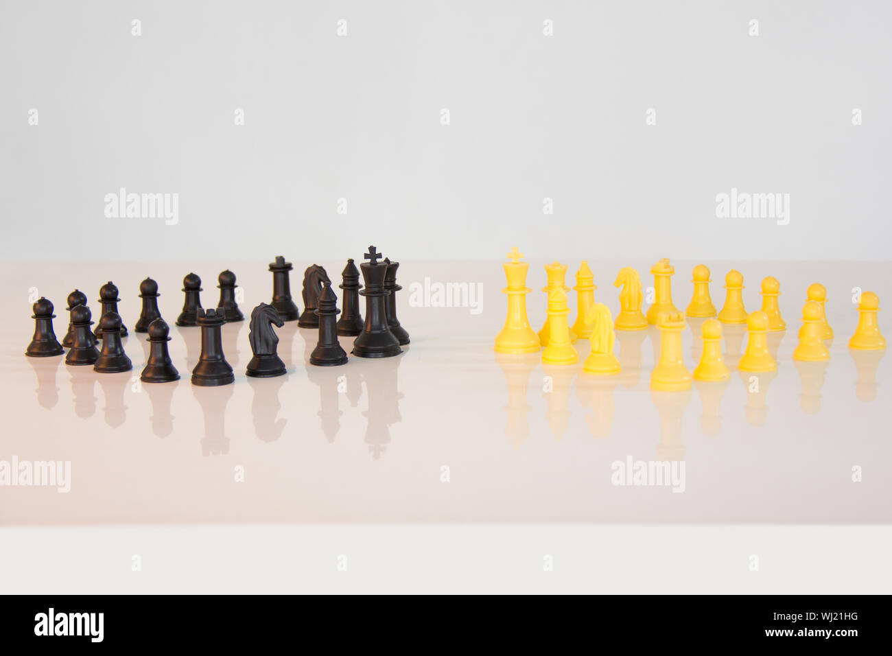 White chess pieces facing opposition on black chess pieces Stock Photo ...