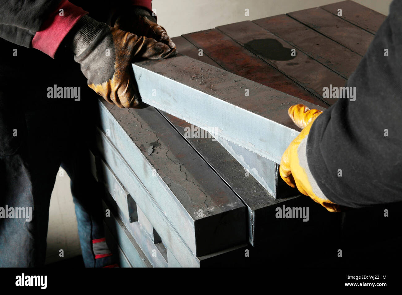 workers and heavy metal blocks Stock Photo - Alamy