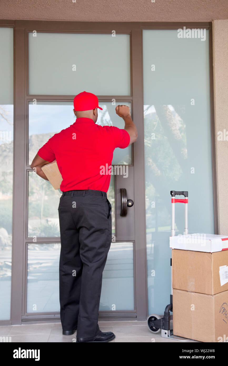 Young man knocking on door hi-res stock photography and images - Alamy