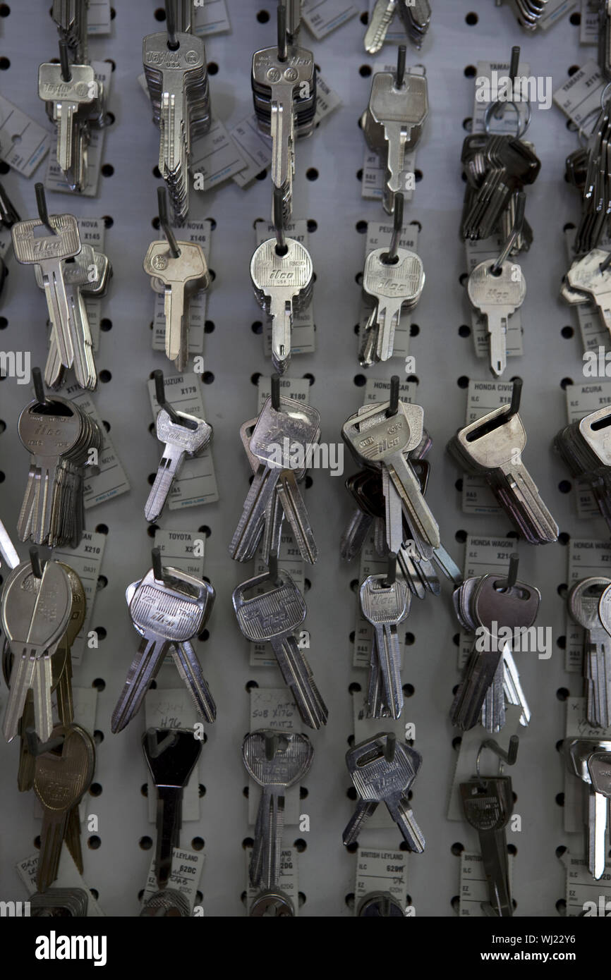 Large group of keys hanging on hooks in store Stock Photo - Alamy