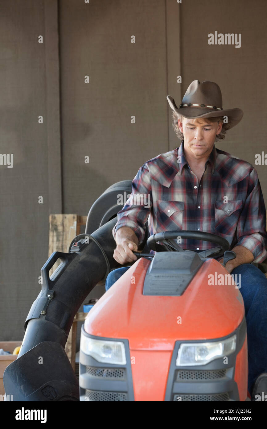 Cowboy driving utility vehicle Stock Photo - Alamy