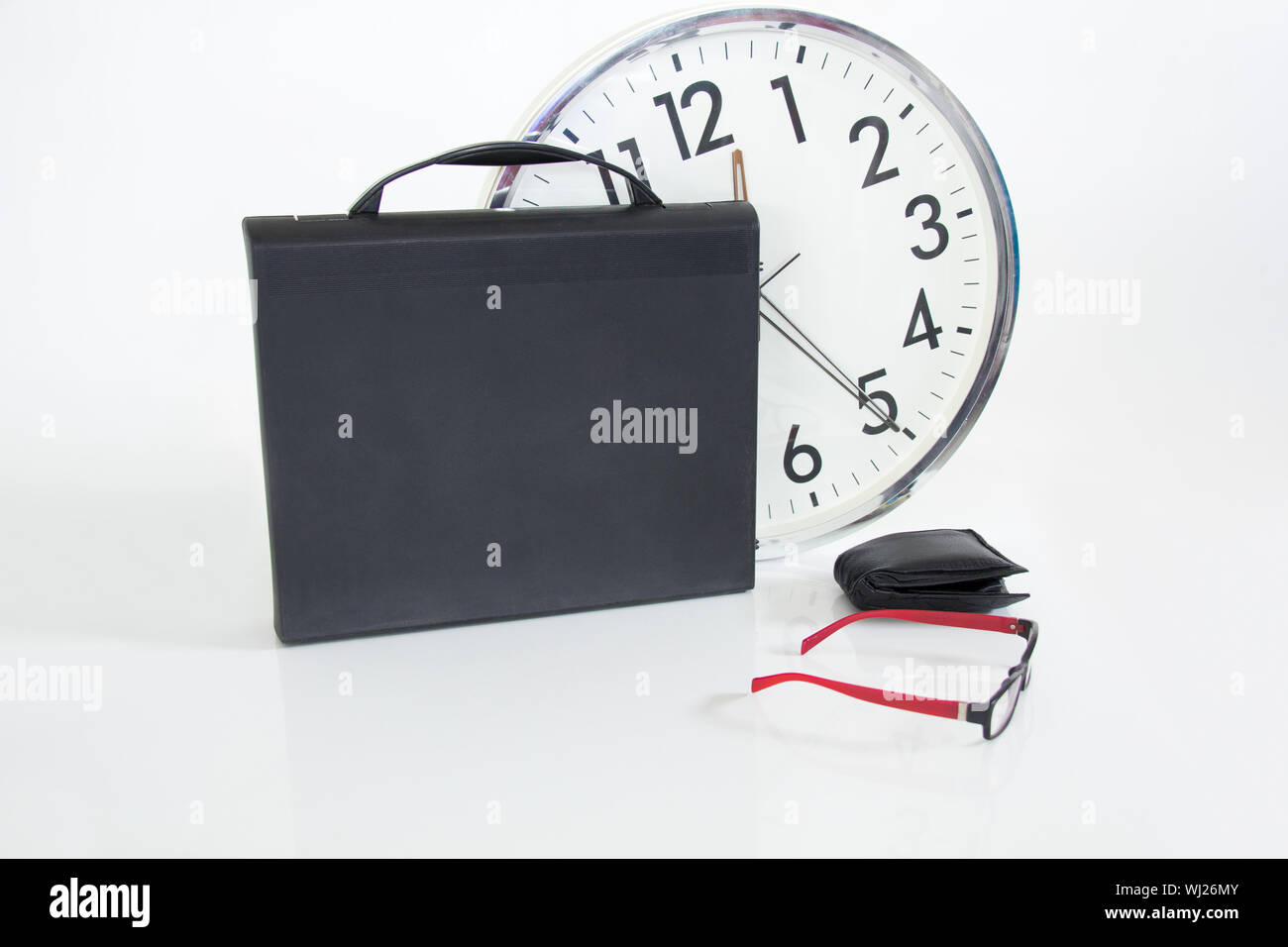 Wall clock with business bag and wallet isolated on white background ...