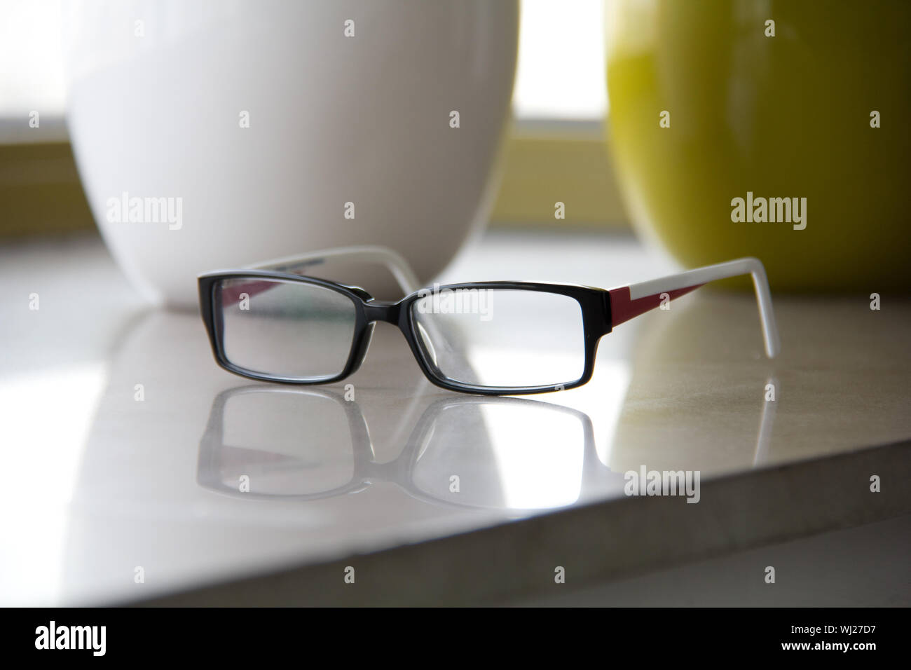 Eyeglasses on window sill Stock Photo - Alamy