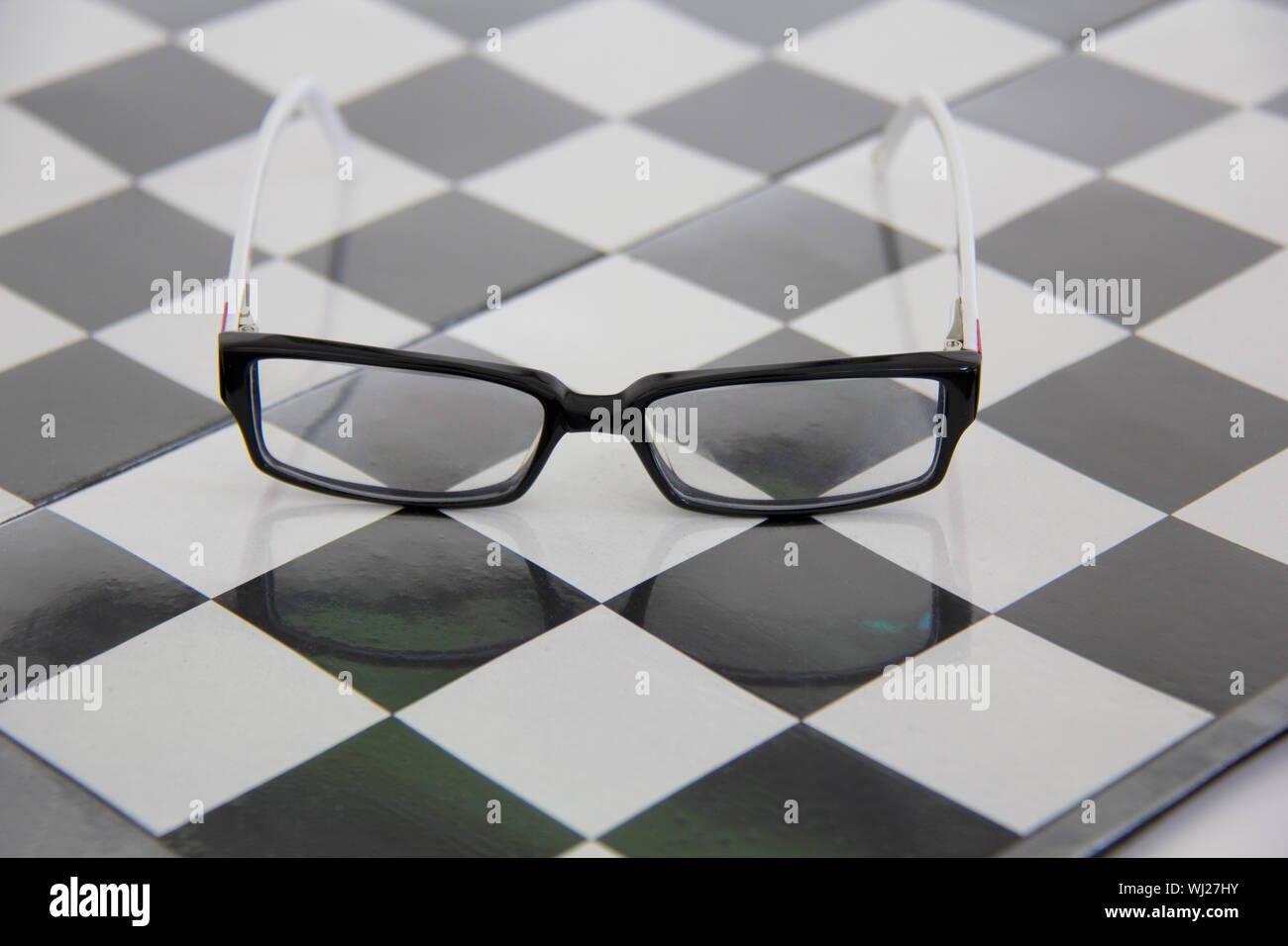 Eyeglasses on chess board Stock Photo - Alamy