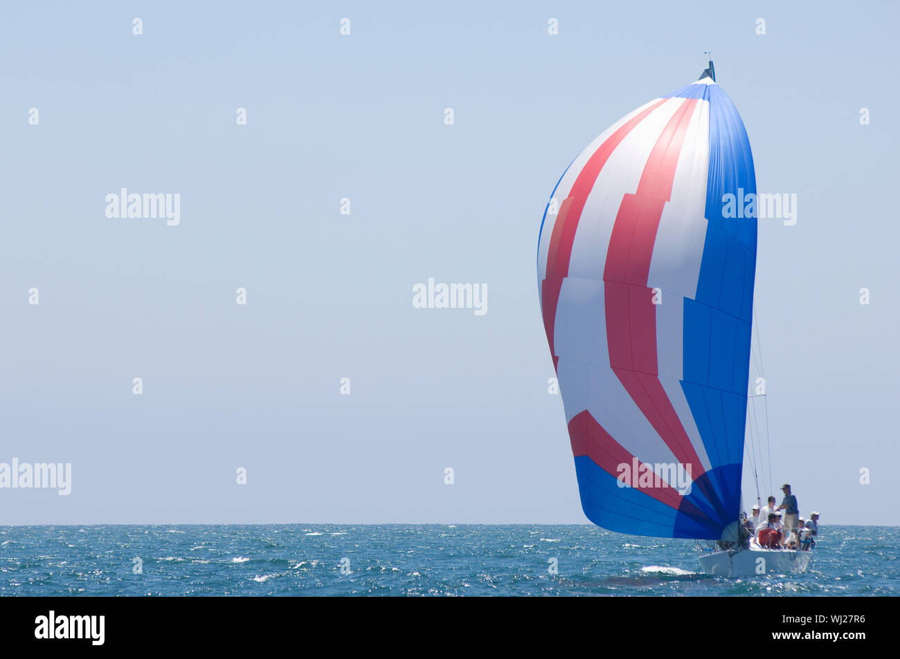 View of a yacht competing in team sailing event Stock Photo - Alamy