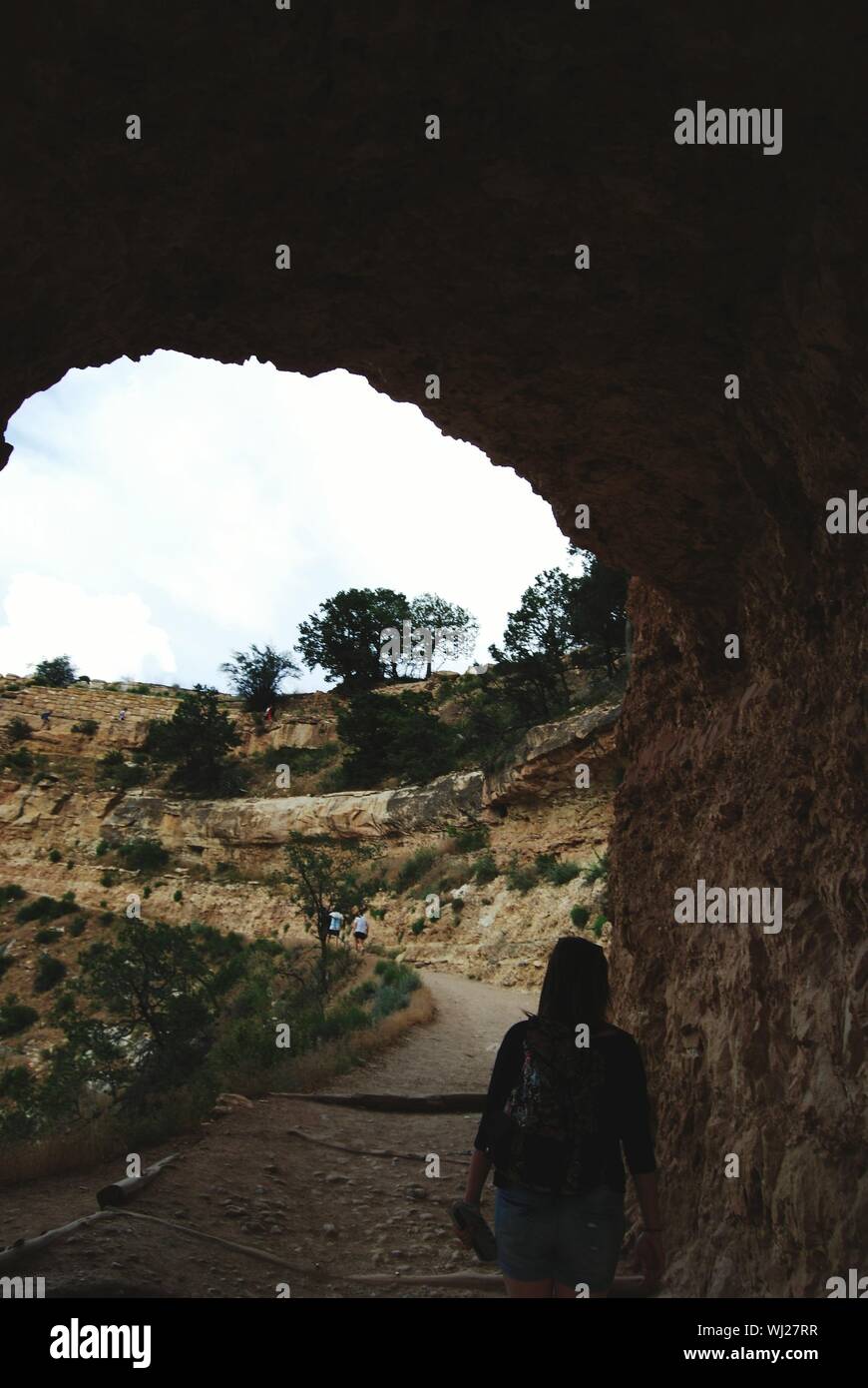 Woman walking in cave hi-res stock photography and images - Alamy