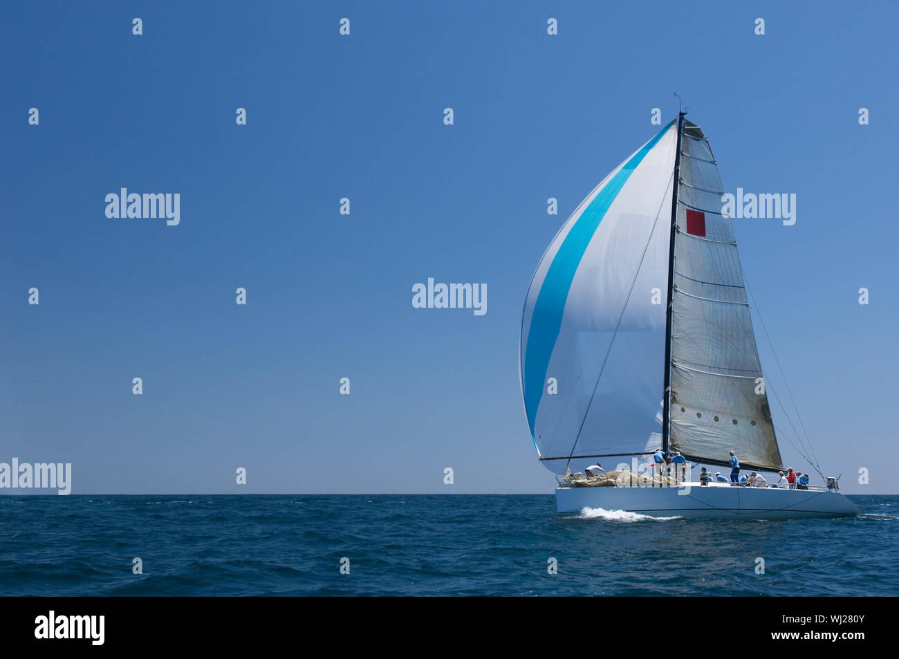 View of a yacht competing in team sailing event Stock Photo - Alamy