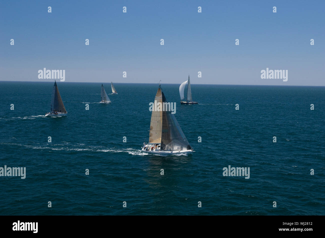 View of five yachts competing in team sailing event Stock Photo - Alamy