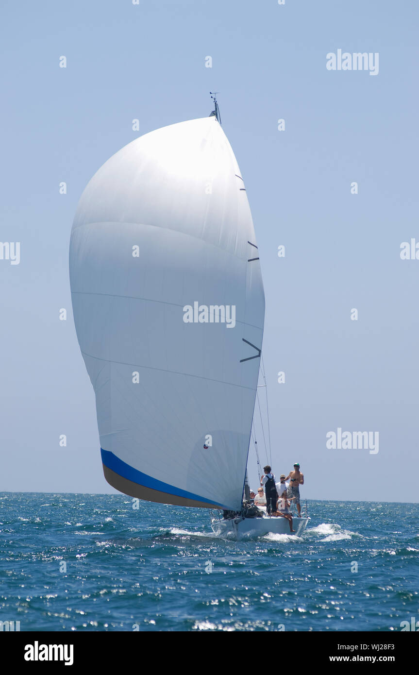 View of a yacht competing in team sailing event Stock Photo - Alamy