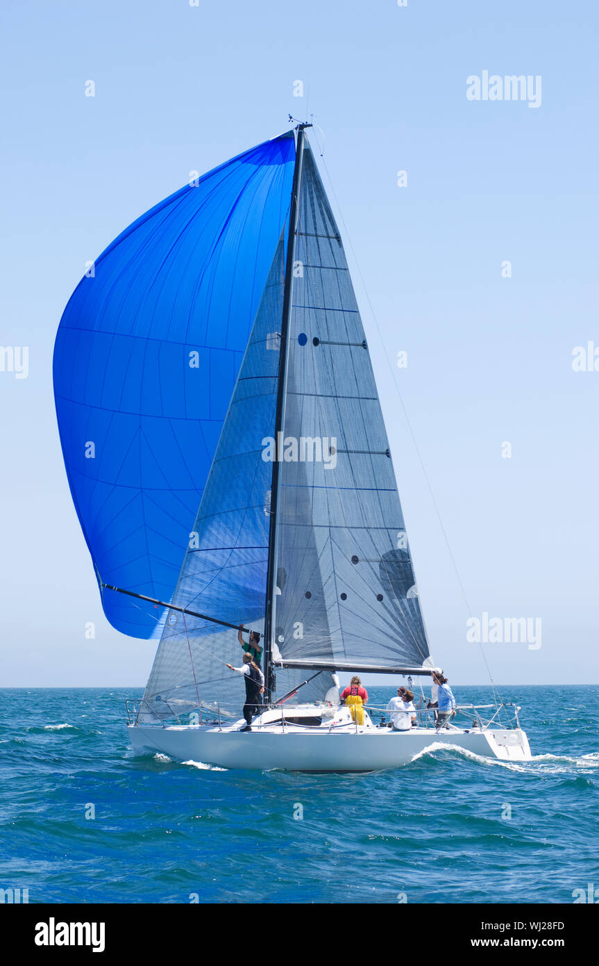 View of a yacht with blue sail competing in team sailing event Stock ...