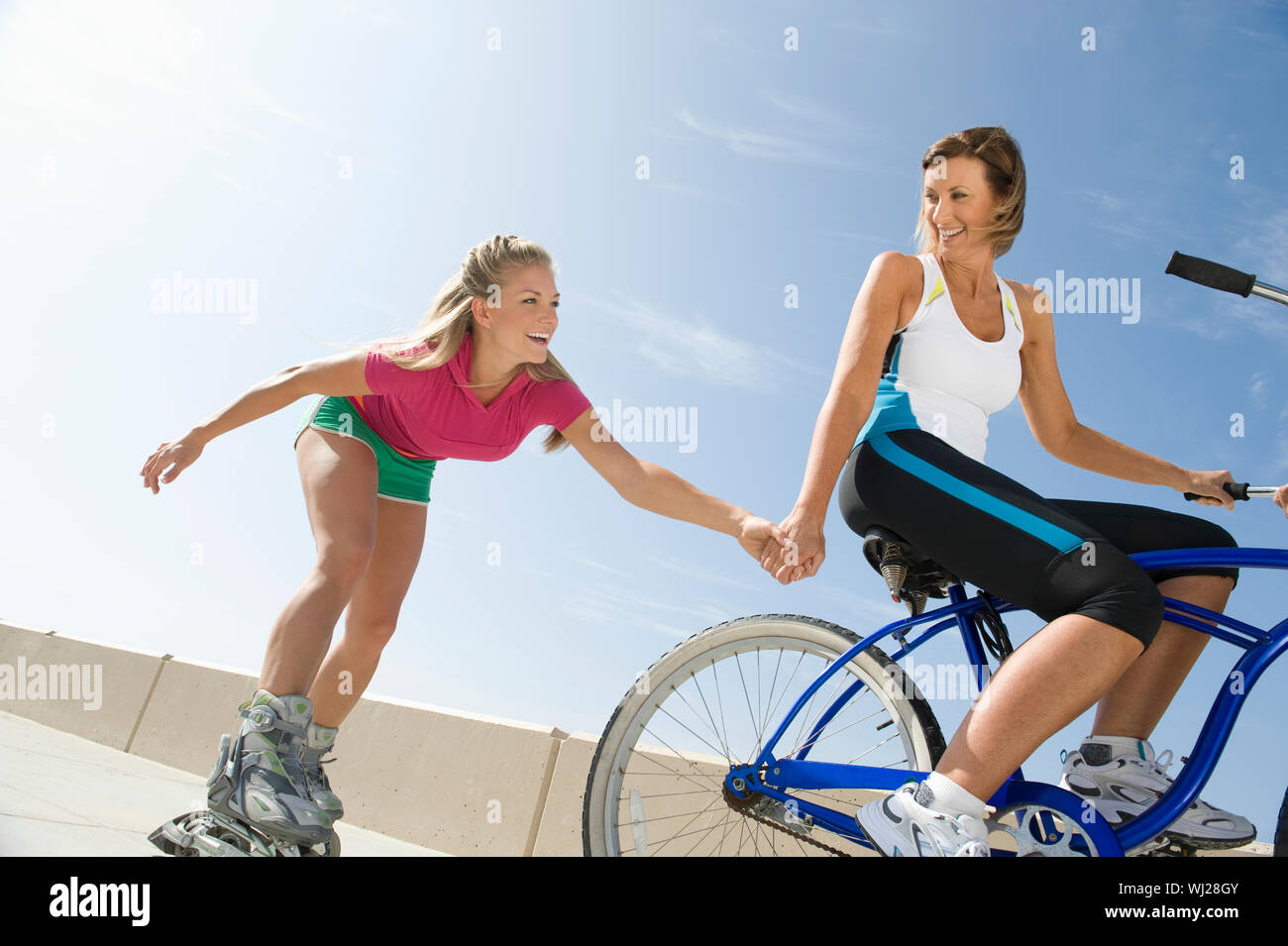 Young women on push bike hi-res stock photography and images - Alamy