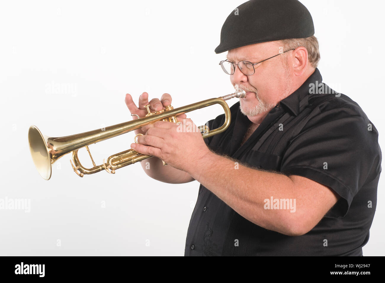 Mature man blowing trumpet isolated over white background Stock Photo ...