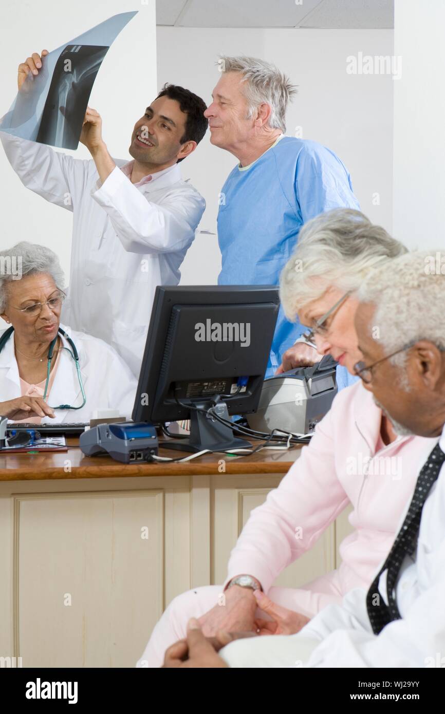 Group of multiethnic doctors and patients in clinic Stock Photo - Alamy