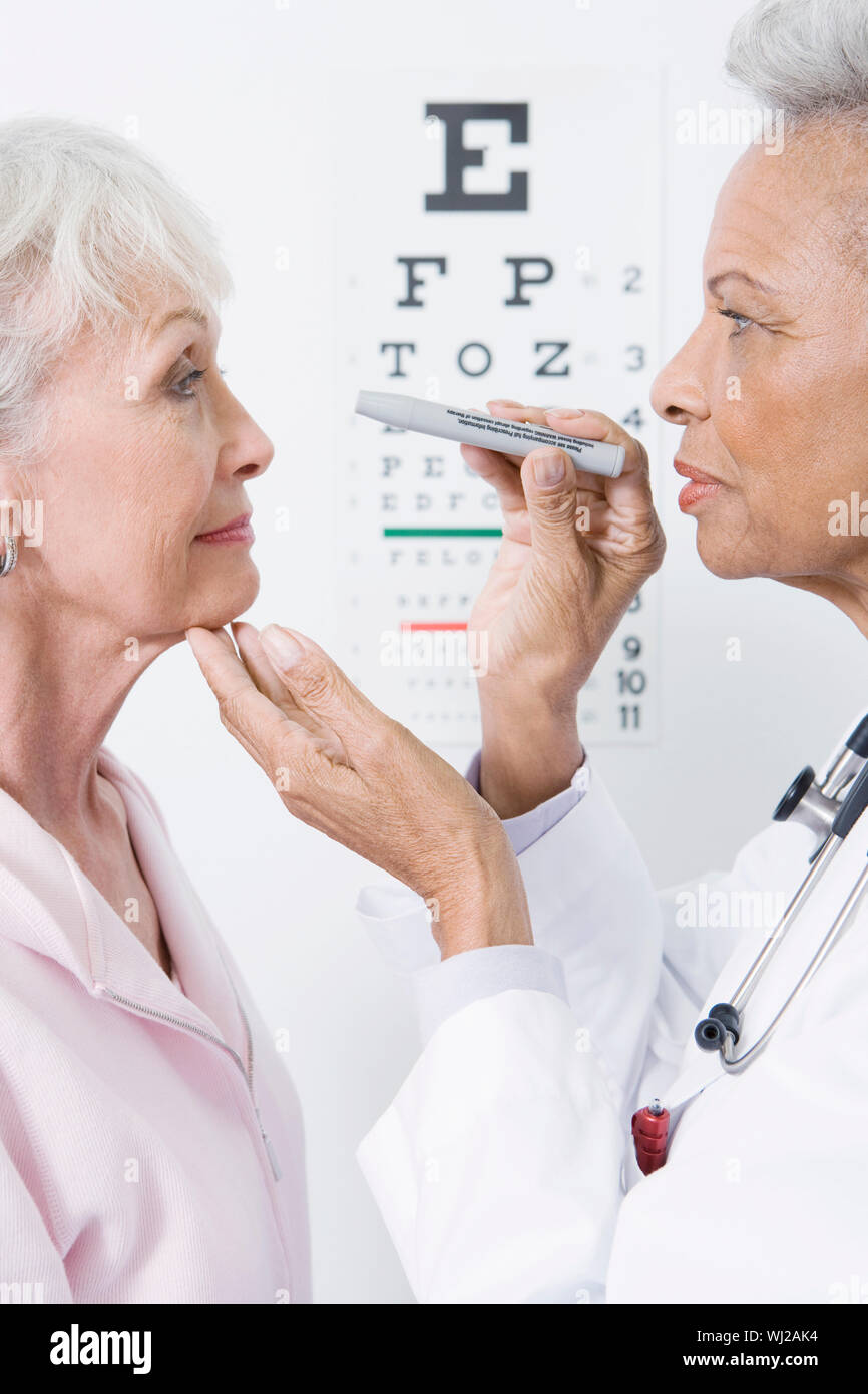 Optometrist examining patients eyes eye hi-res stock photography and ...