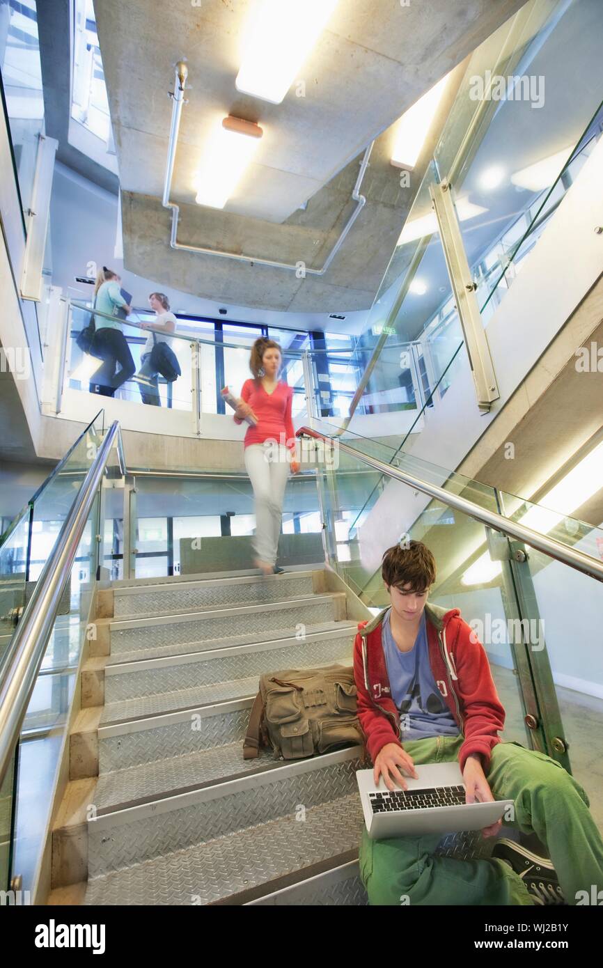 University Student Using Laptop On Staircase Stock Photo - Alamy