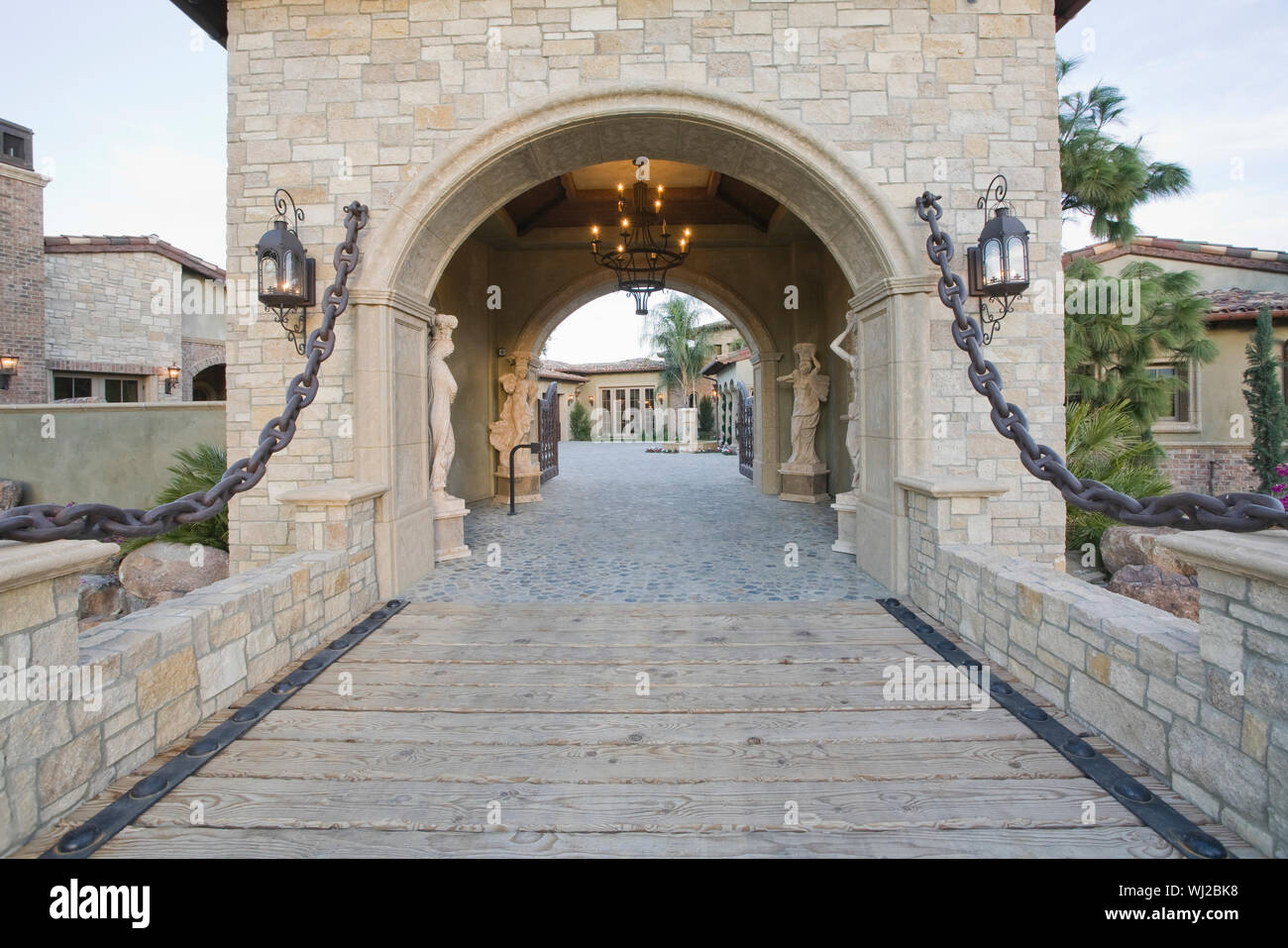 Stone gateway with arched structure to modern home Stock Photo - Alamy