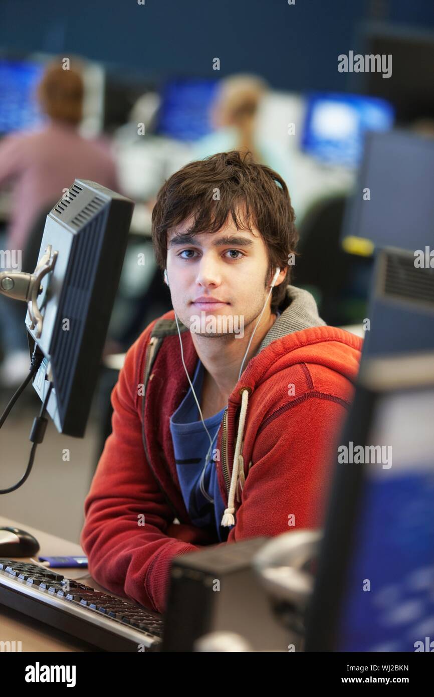 Student Using Computer And Listening Music Stock Photo - Alamy
