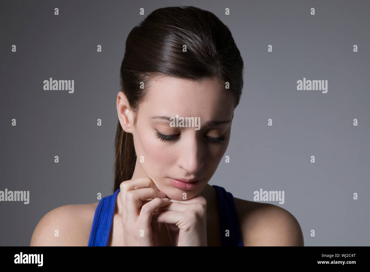 Young dishearten female isolated over grey background Stock Photo - Alamy
