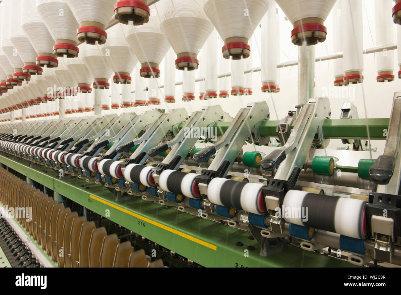 Closeup of machinery part at spinning factory Stock Photo - Alamy