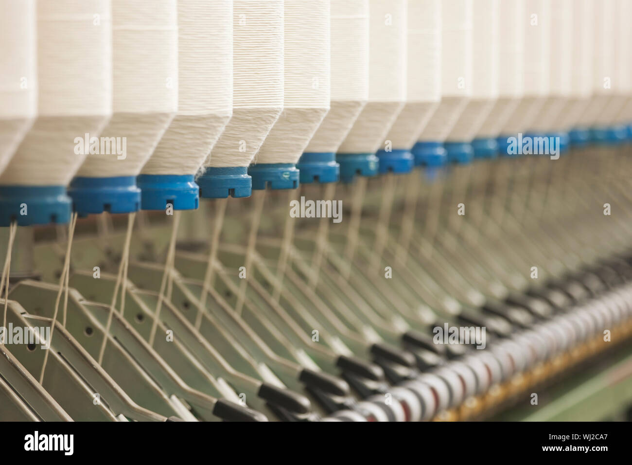 Closeup of machinery part at spinning factory Stock Photo - Alamy