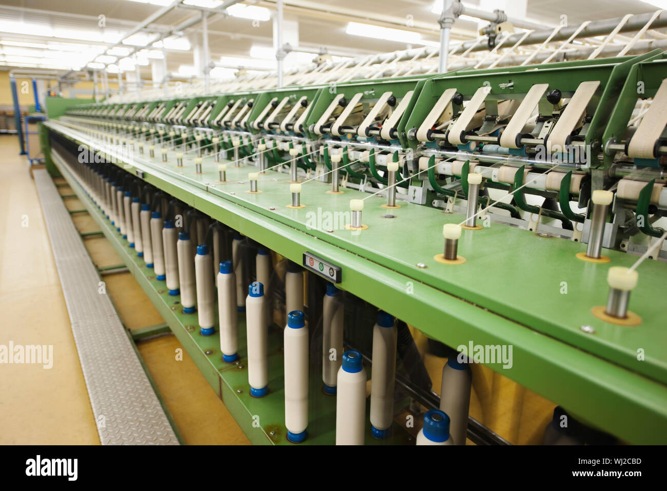 Closeup of machinery part at spinning factory Stock Photo - Alamy