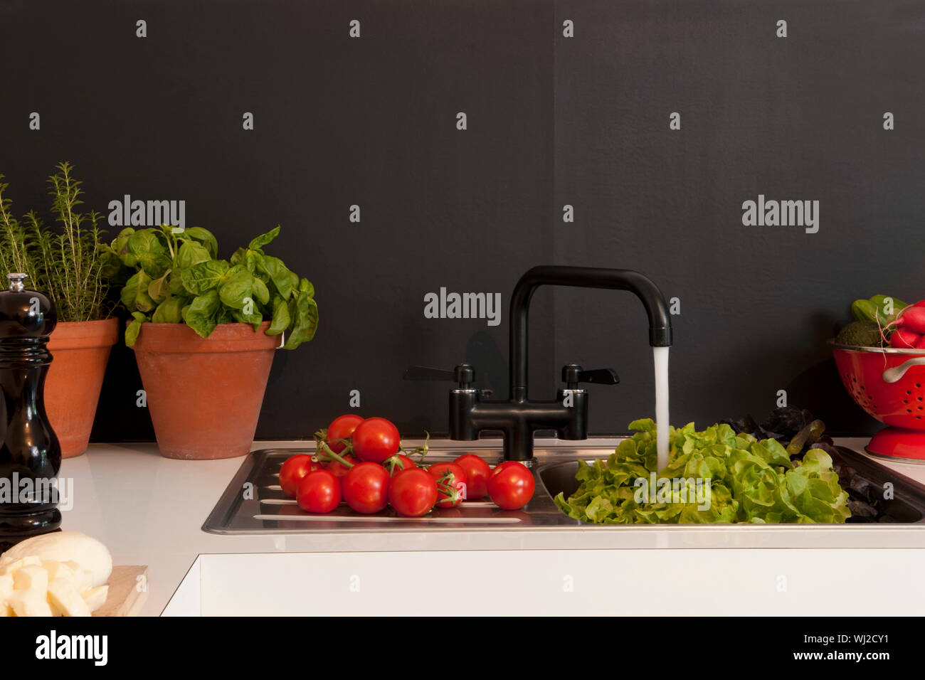 Washing vegetables in the kitchen sink Stock Photo - Alamy