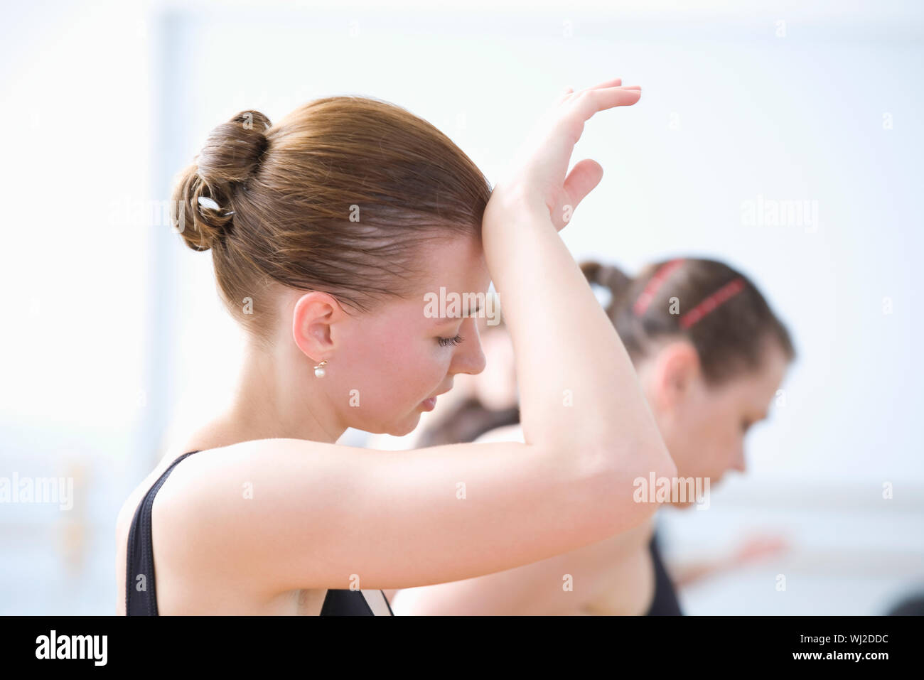 Side view of tired young female ballet dancer in rehearsal room Stock ...