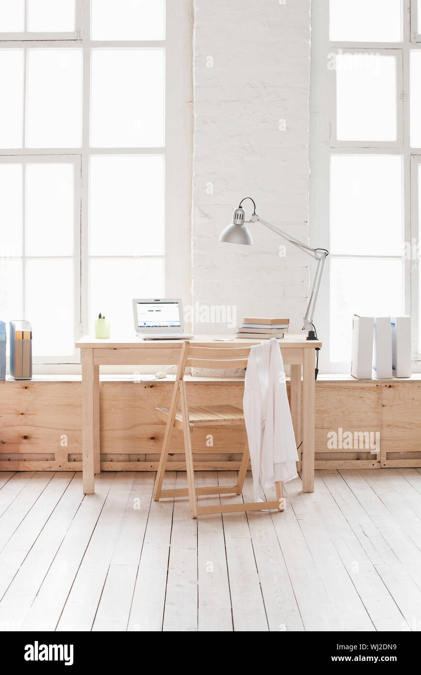 View of empty room with wooden table and chair in loft apartment Stock ...