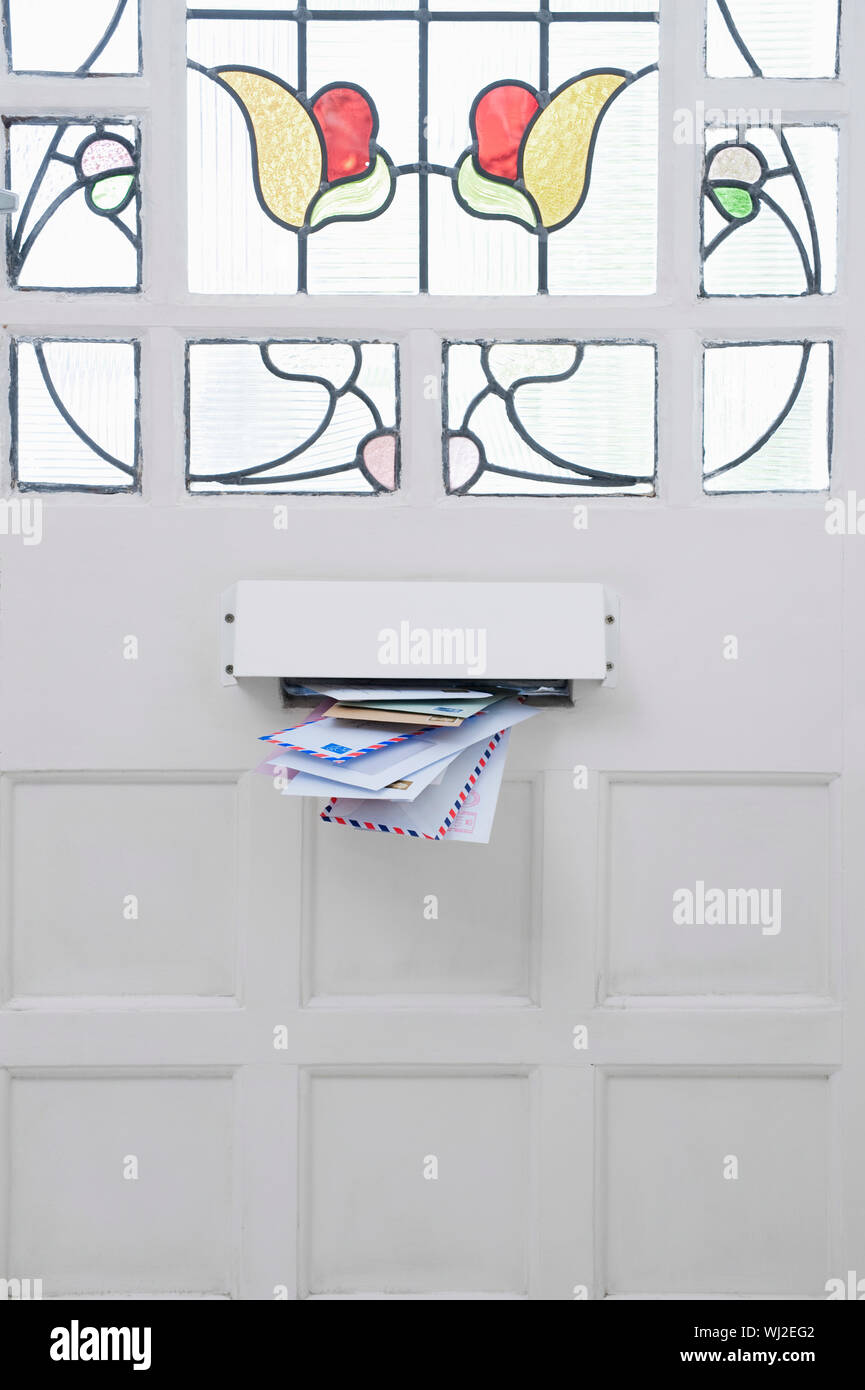 Stream of letters coming through the letter box Stock Photo - Alamy