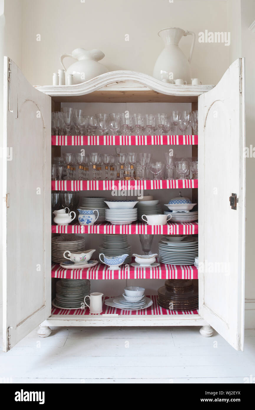 Open storage cupboard showing display of homeware Stock Photo - Alamy