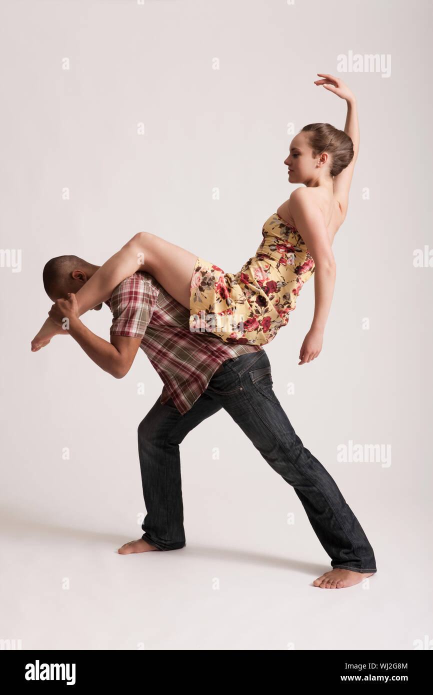 Full length of modern dancers performing over white background Stock ...
