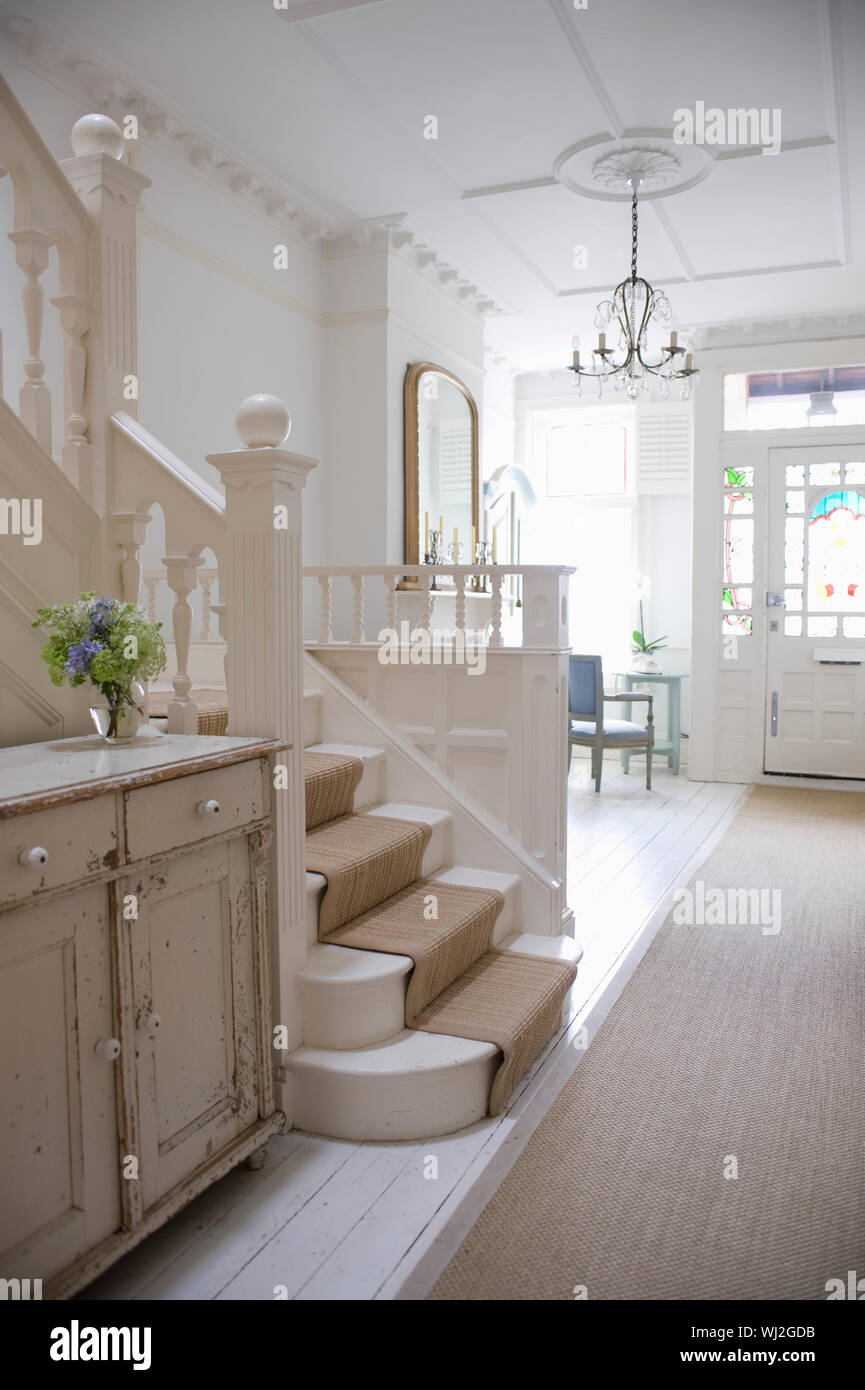 Entry hall with stairway and front door Stock Photo - Alamy