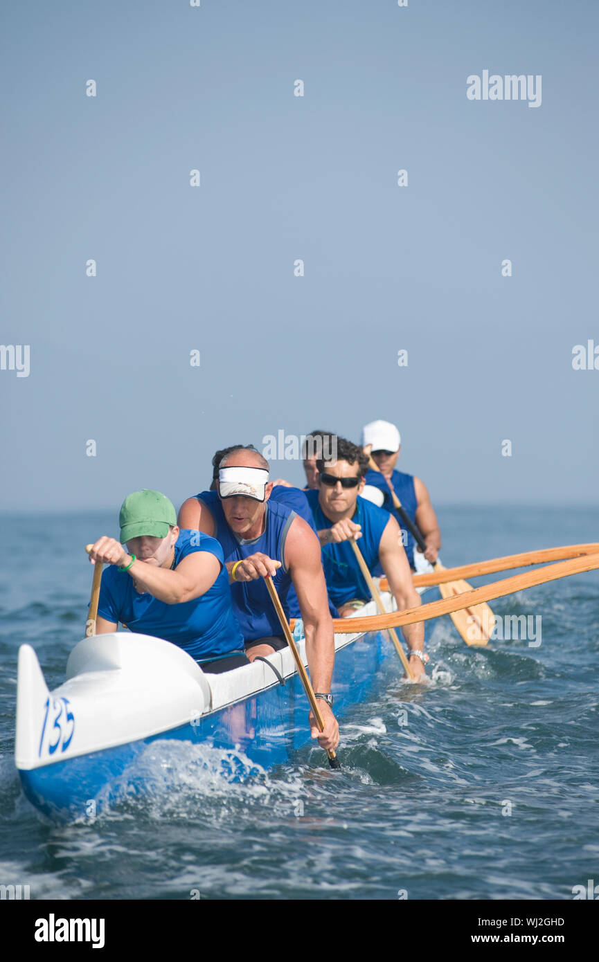 Multiethnic outrigger canoeing team in race Stock Photo - Alamy
