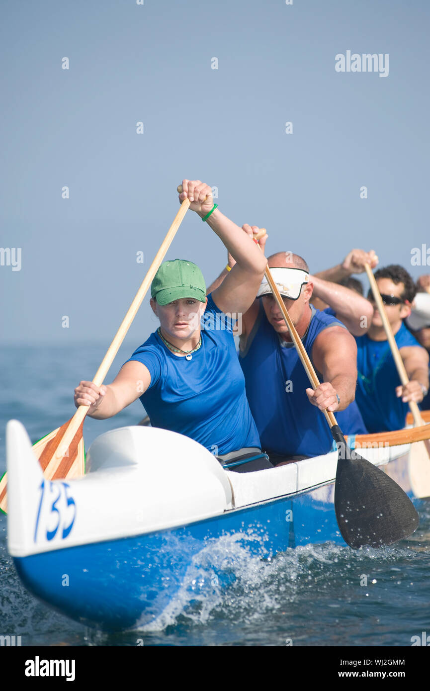 Multiethnic outrigger canoeing team in race Stock Photo - Alamy