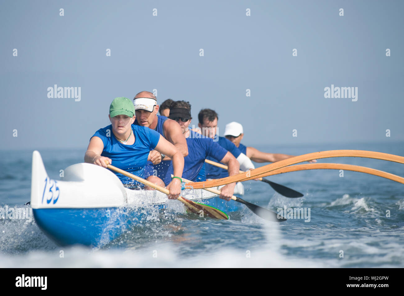 Multiethnic outrigger canoeing team in race Stock Photo - Alamy