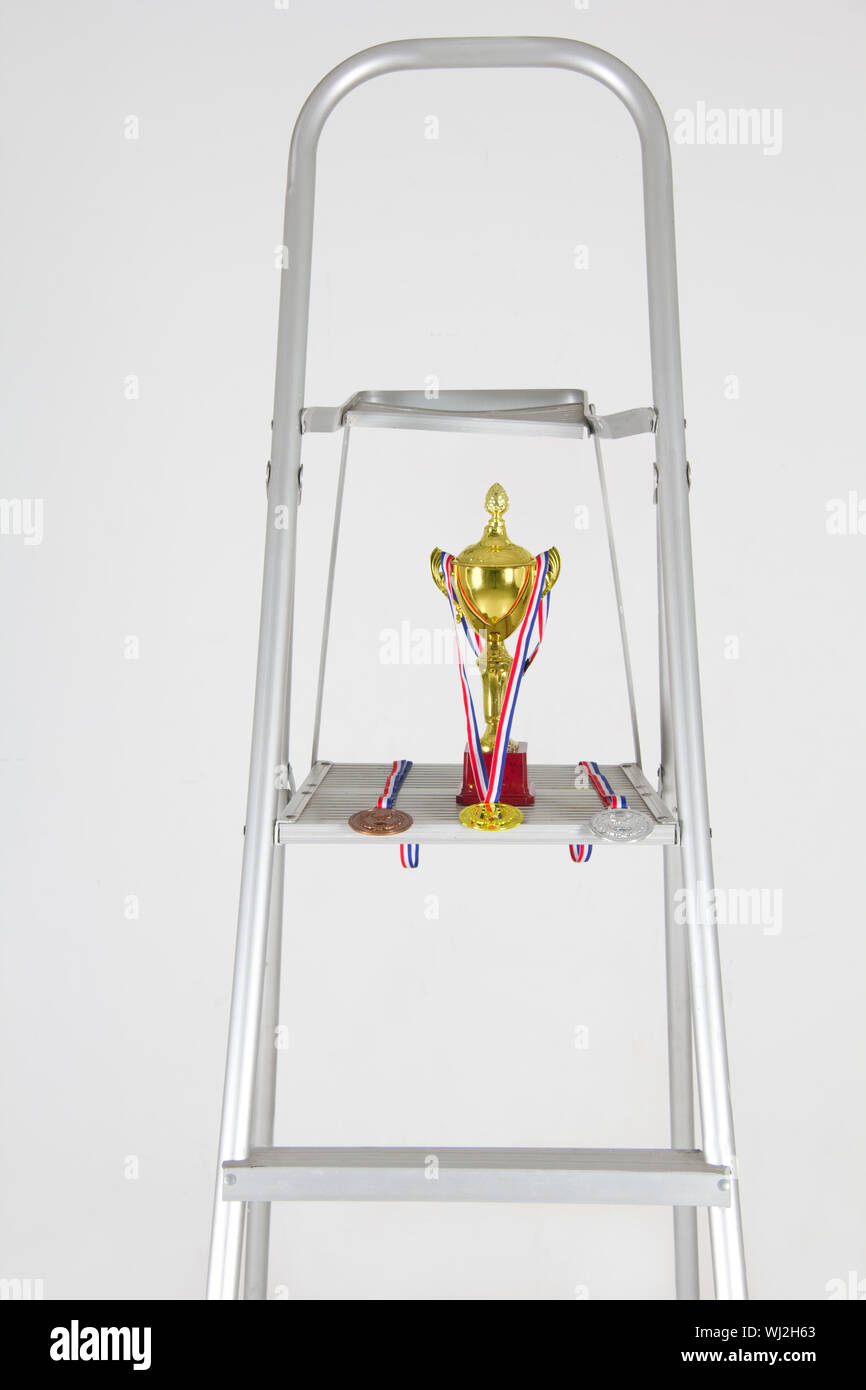 Trophy with medals on step ladder Stock Photo - Alamy