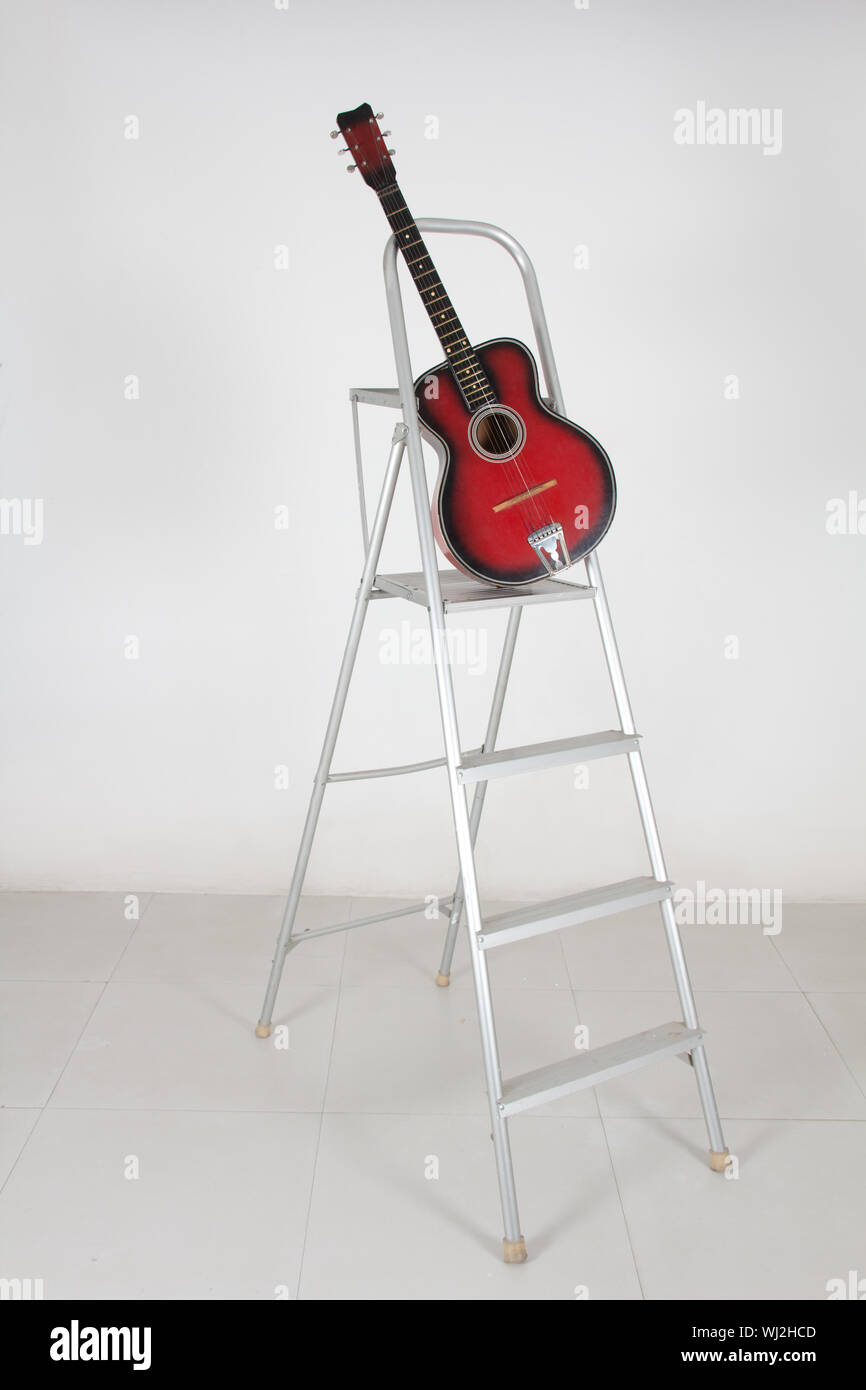 Guitar on step ladder Stock Photo - Alamy