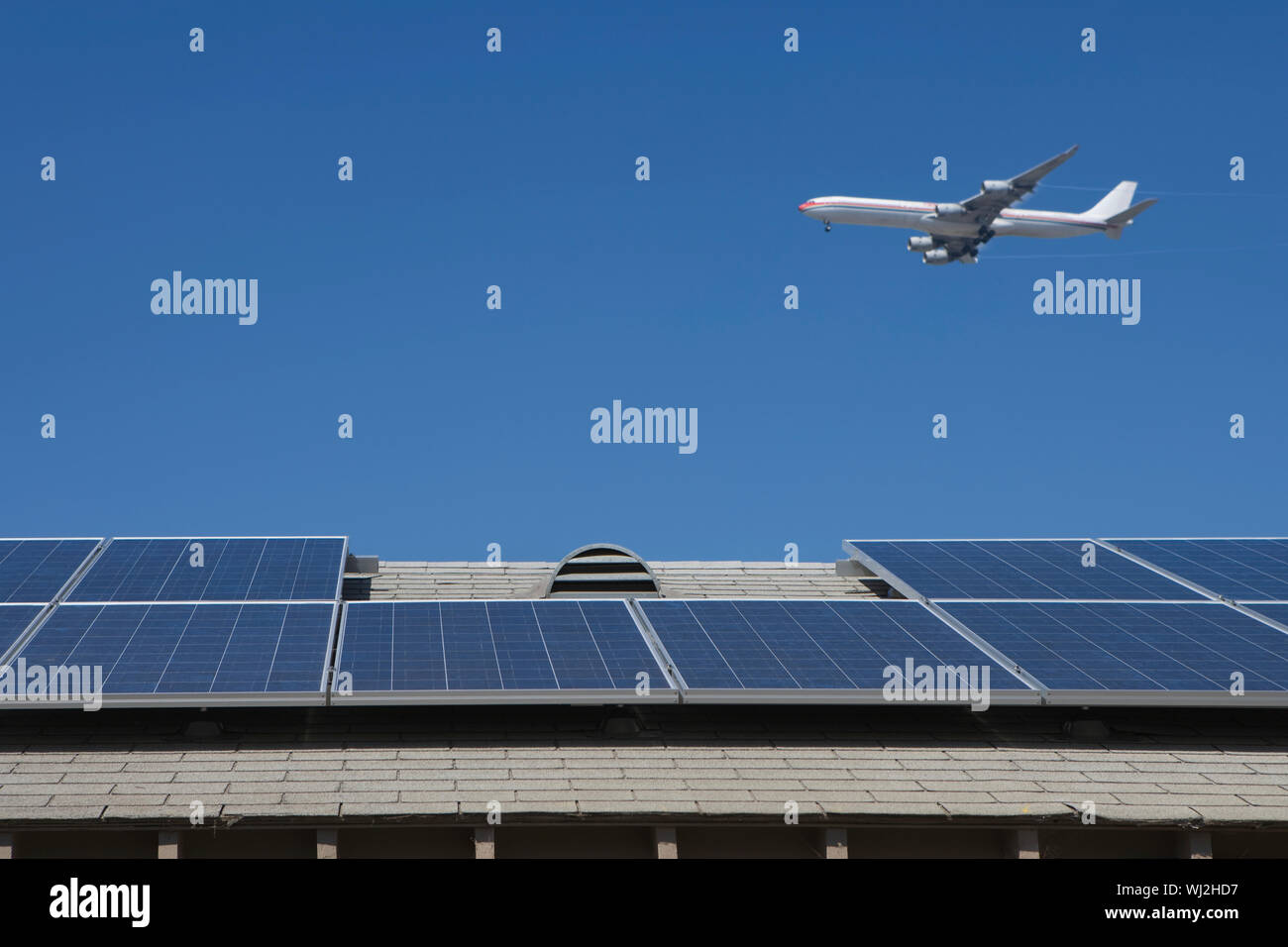 Aeroplane flying over rooftop with solar panels in Los Angeles ...