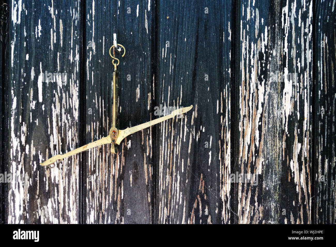 antique small scale hanging on a wall of old weathered wooden garden ...