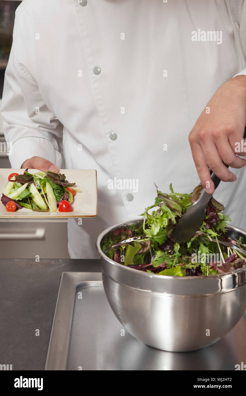 Male chef preparing leaf vegetables in commercial kitchen Stock Photo ...
