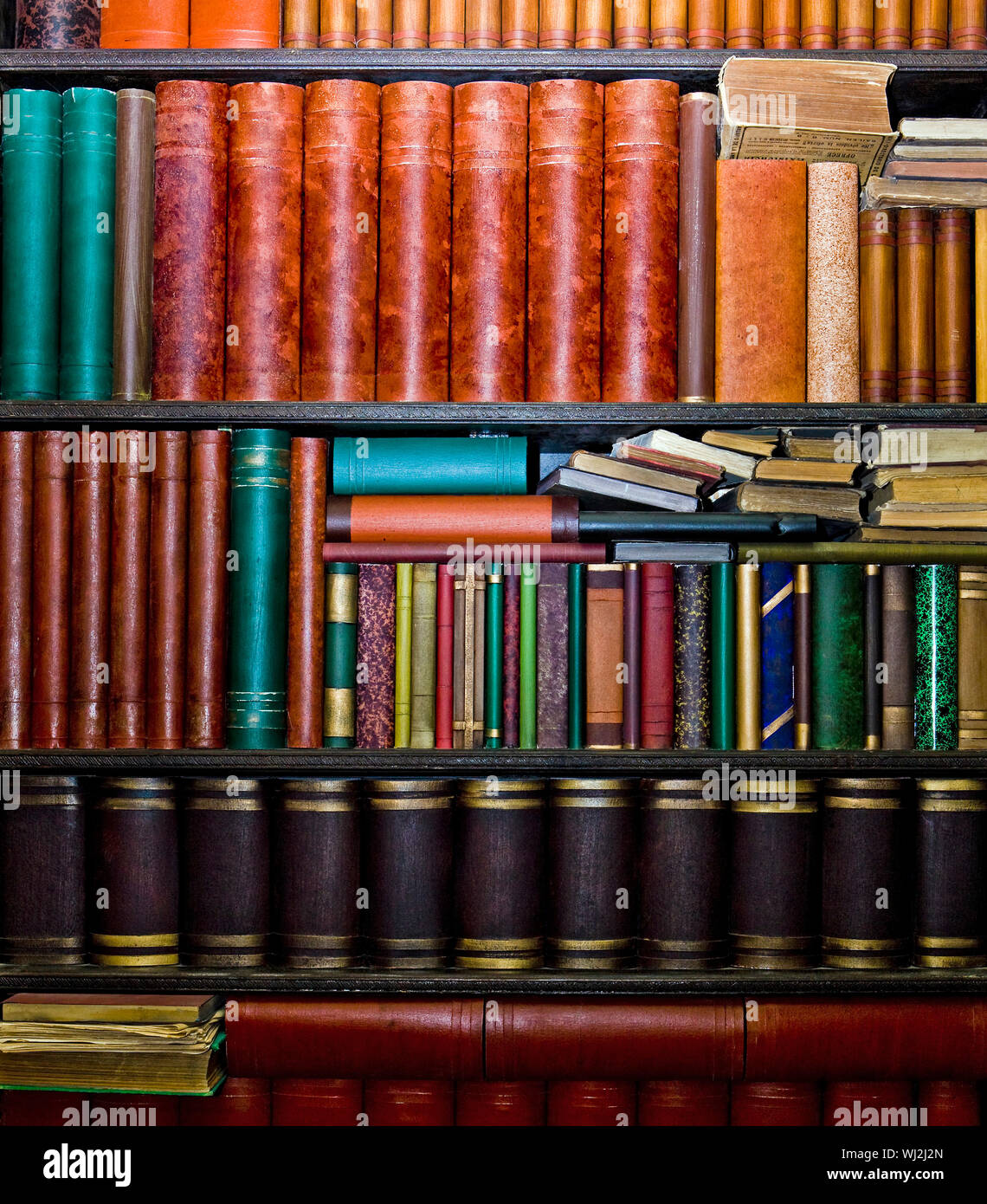 Row of old books arranged in bookshelves Stock Photo - Alamy
