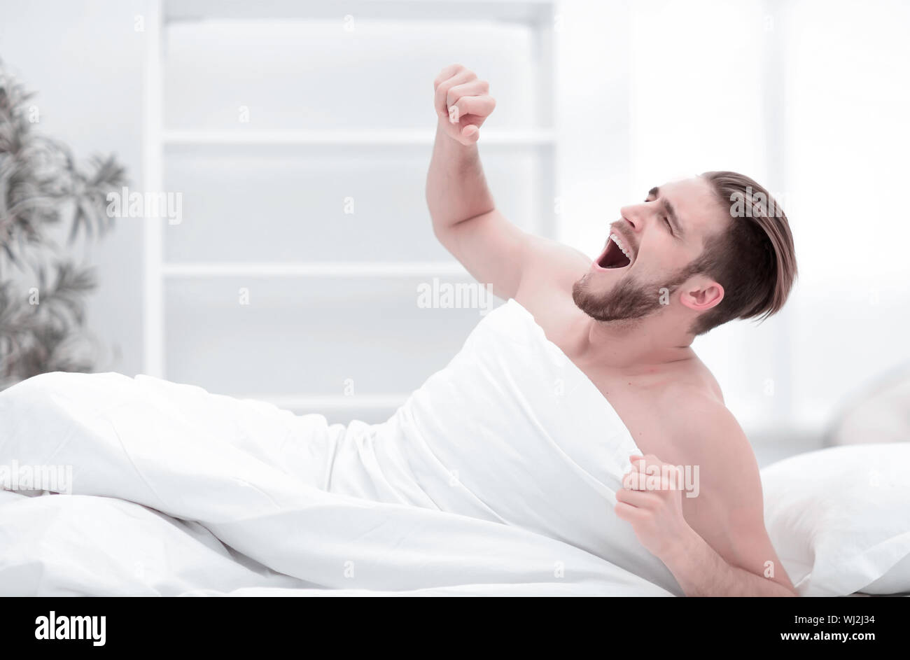 happy man waking up in a comfortable room Stock Photo - Alamy