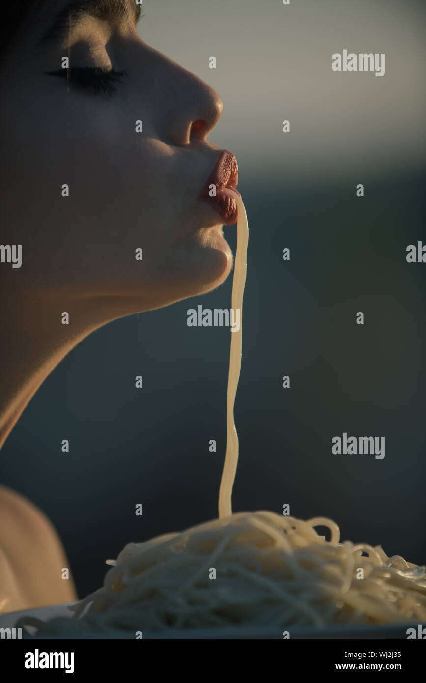 Italian macaroni or spaghetti for dinner, cook. Chef woman with red ...