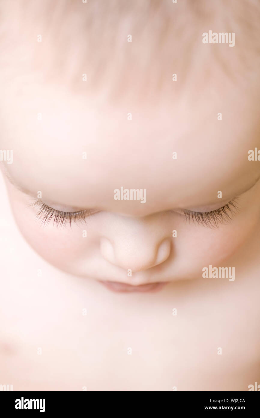 Closeup of baby boy looking down Stock Photo - Alamy