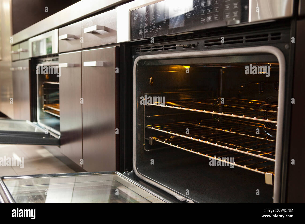 Closeup of open oven in commercial kitchen Stock Photo - Alamy