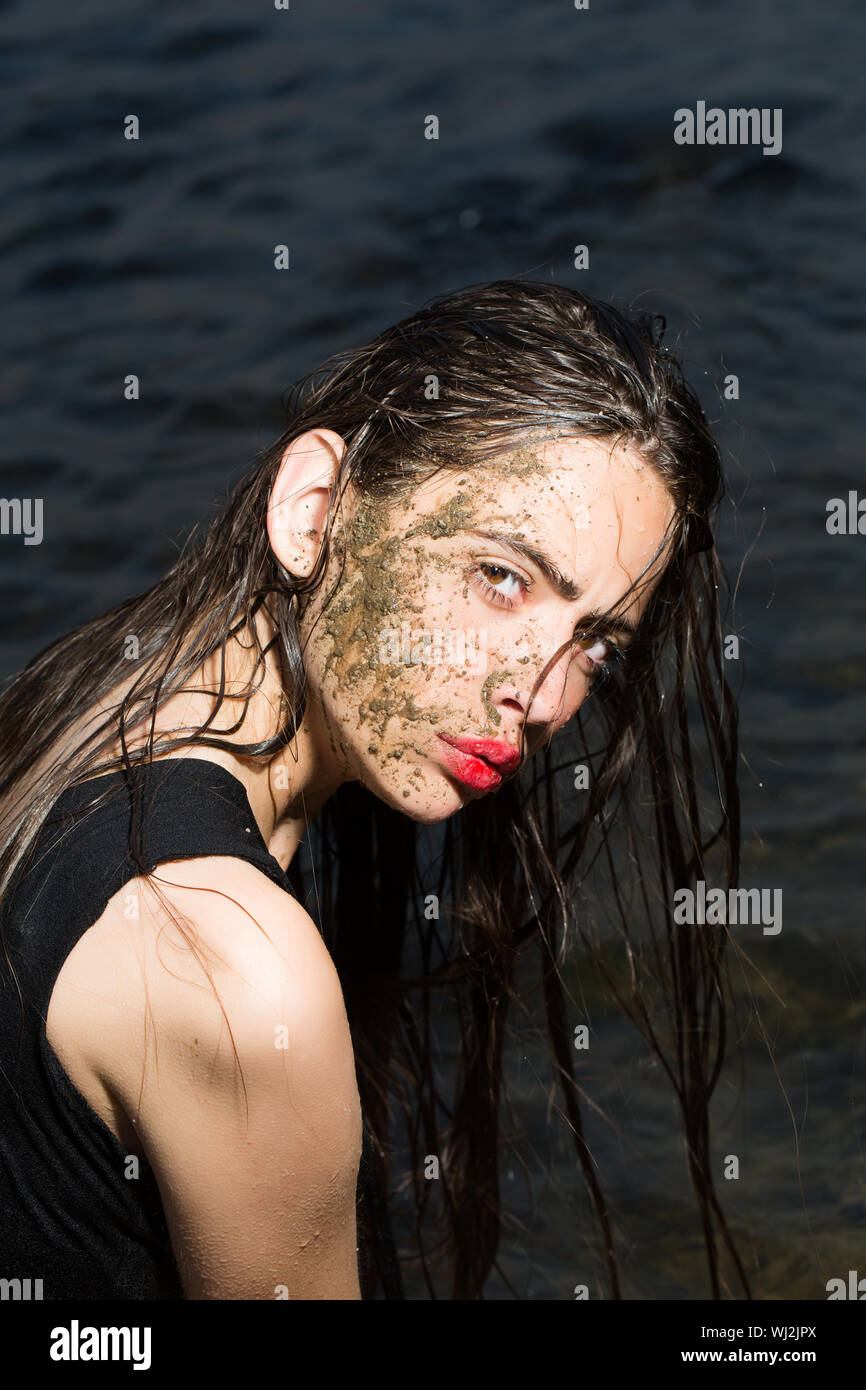 a close up of a woman's face covered in mud Stock Photo - Alamy