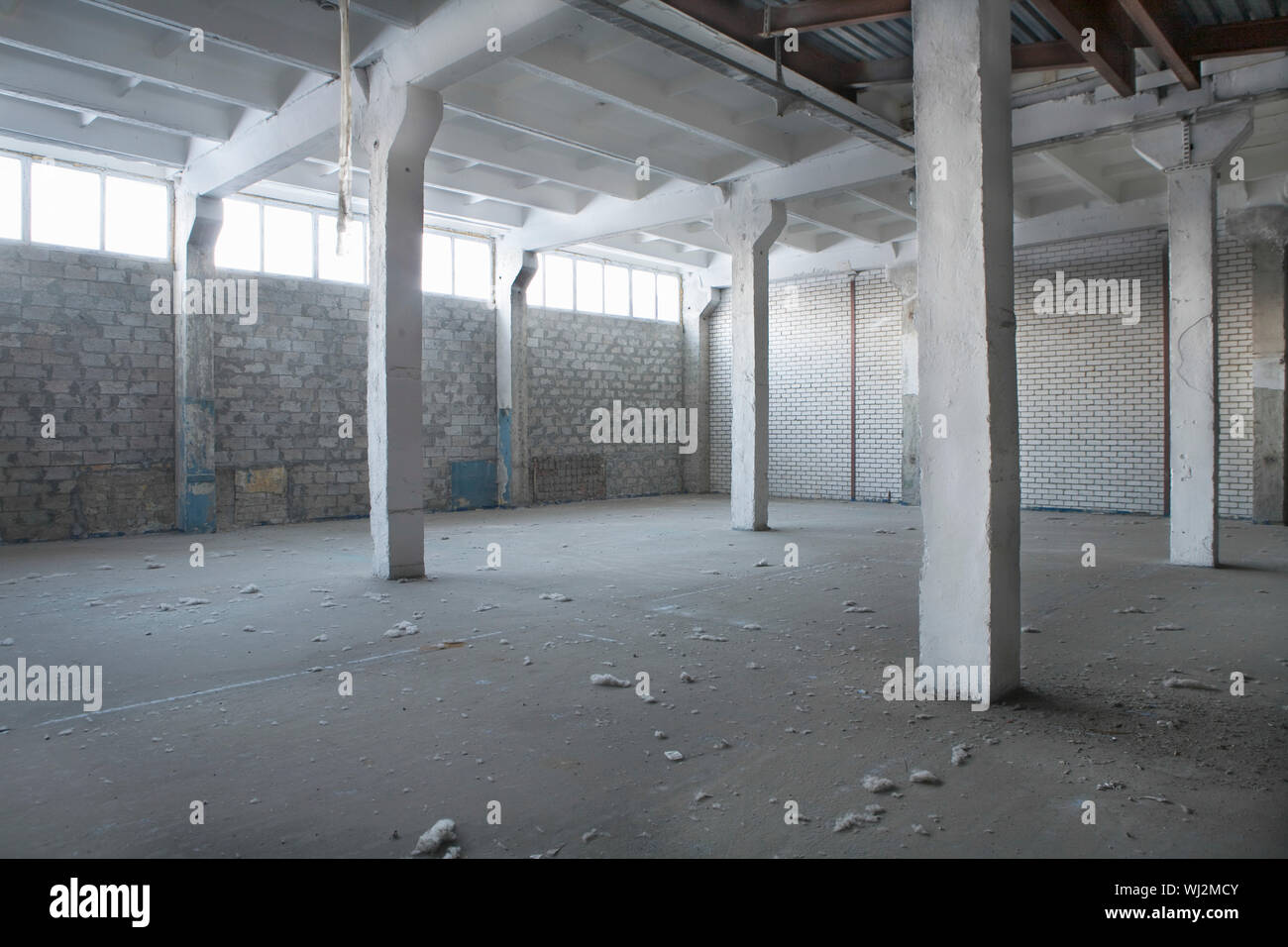 Interior of an empty abandoned warehouse Stock Photo - Alamy