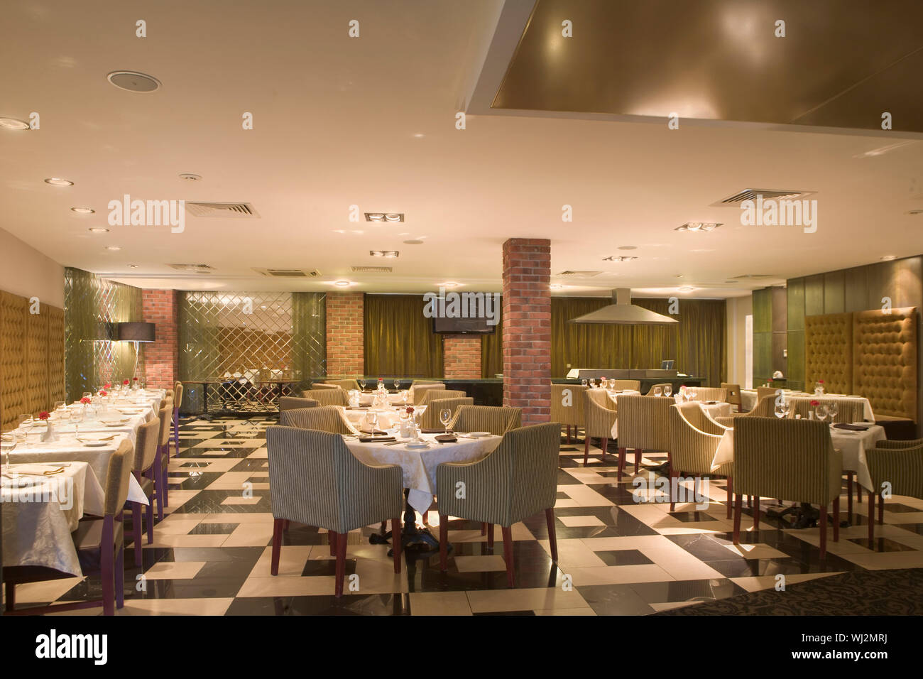 An interior of a luxurious hotel room with tables set for meal Stock ...