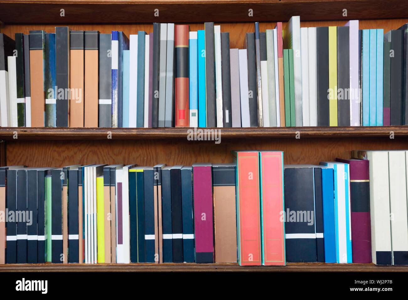 Books on the shelves of a library Stock Photo - Alamy